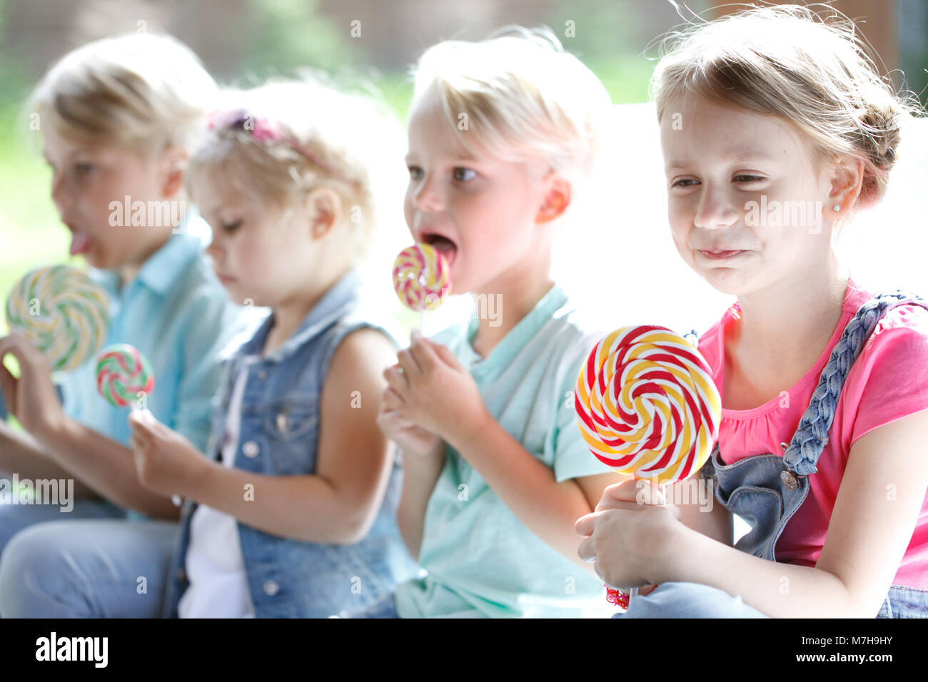 Group of happy smiling children with lollipops outdoors Stock Photo - Alamy
