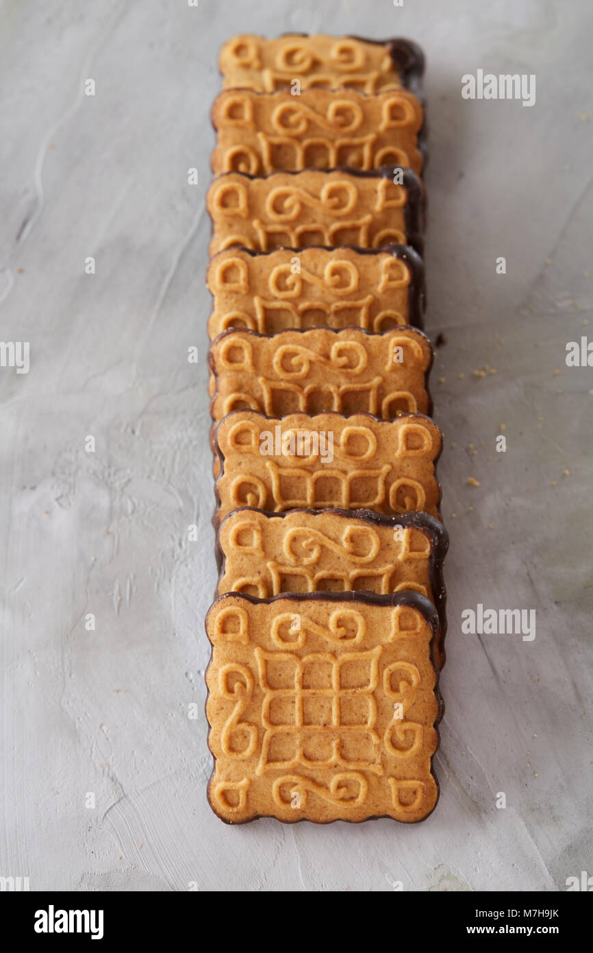 Square biscuits arranged in pattern on light textured background, top ...