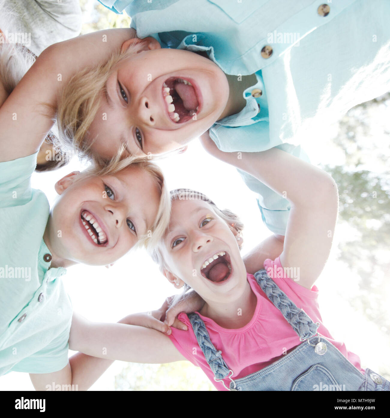 Group of smiling children looking down into camera Stock Photo - Alamy