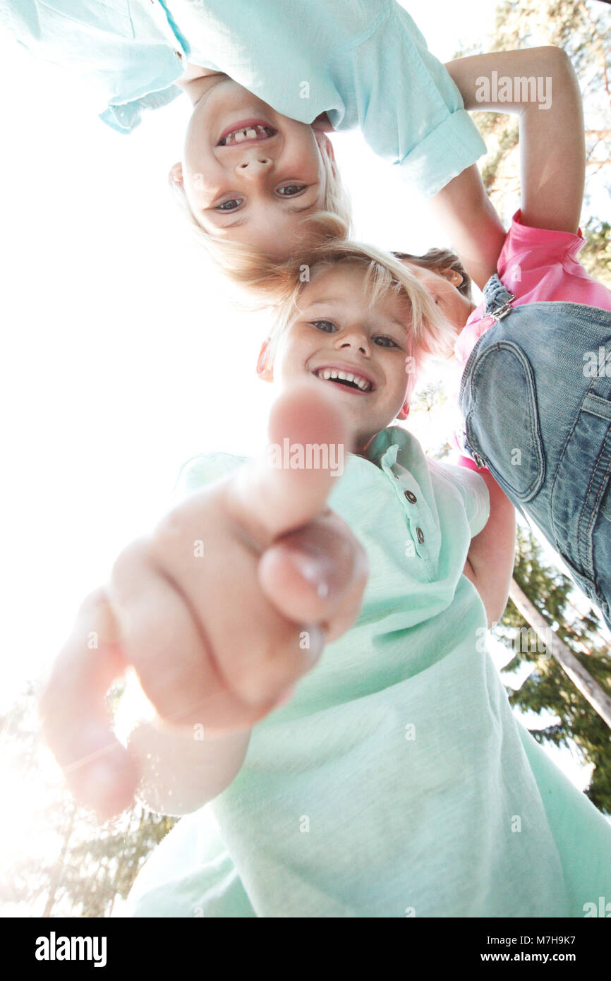 Group of smiling children looking down into camera Stock Photo - Alamy