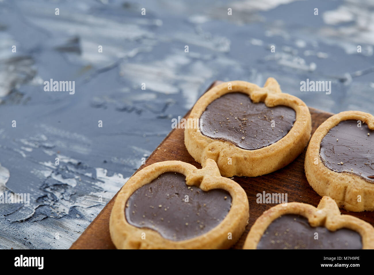 Top view close-up picture of tasty apple-shaped cookies on the cutting ...