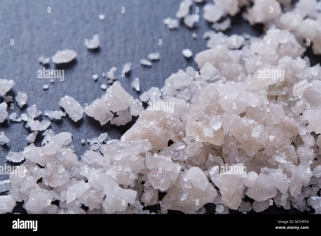 Pile of salt crystals isolated over the dark background, close-up,top ...