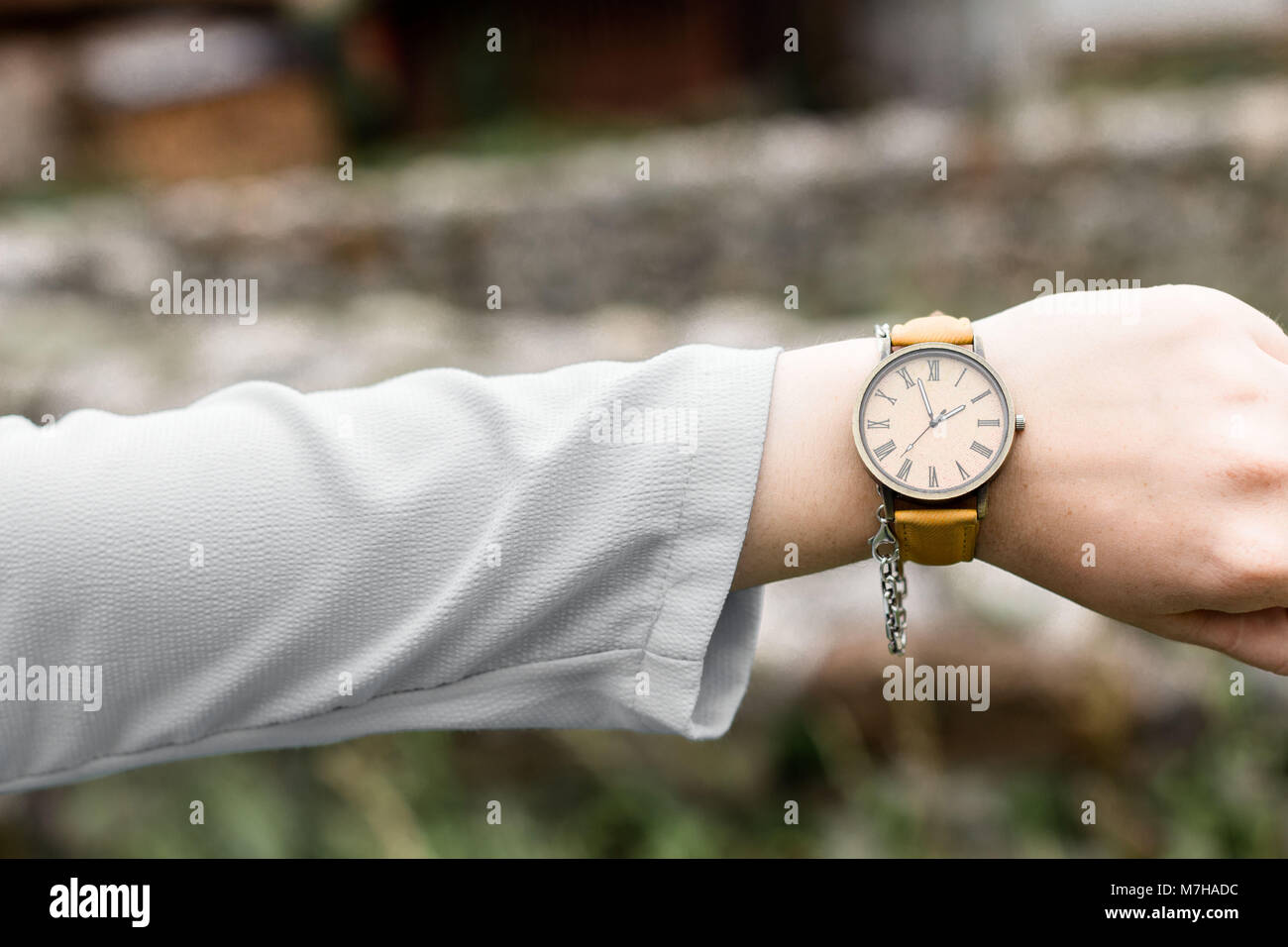 young woman wearing yellow watch Stock Photo - Alamy