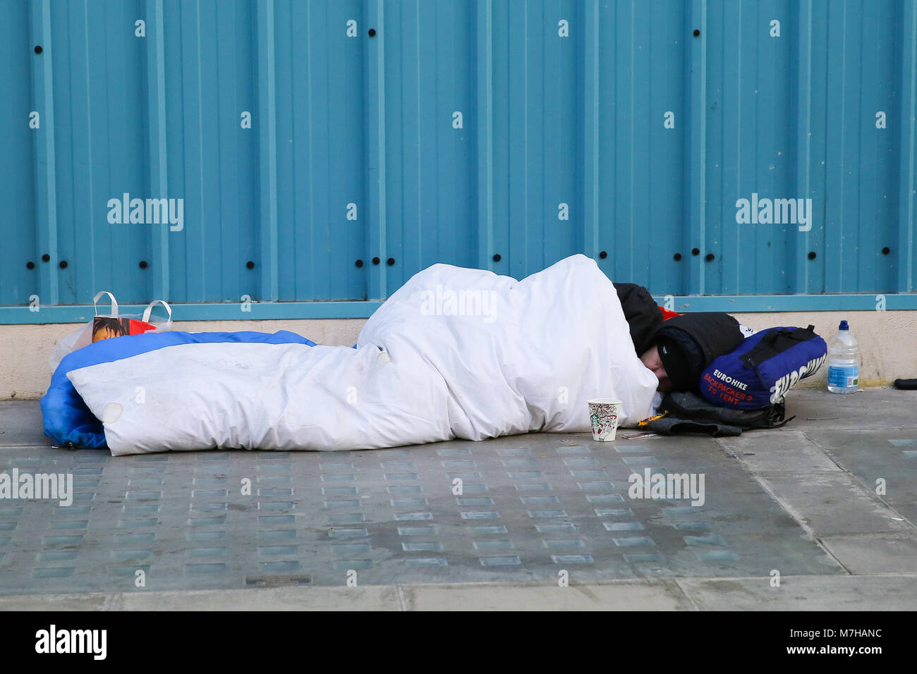 A homeless person sleeping in a sleeping bag in Oxford Street ...