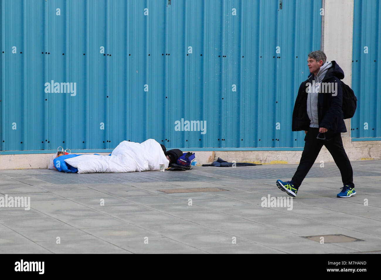 A homeless person sleeping in a sleeping bag in Oxford Street ...