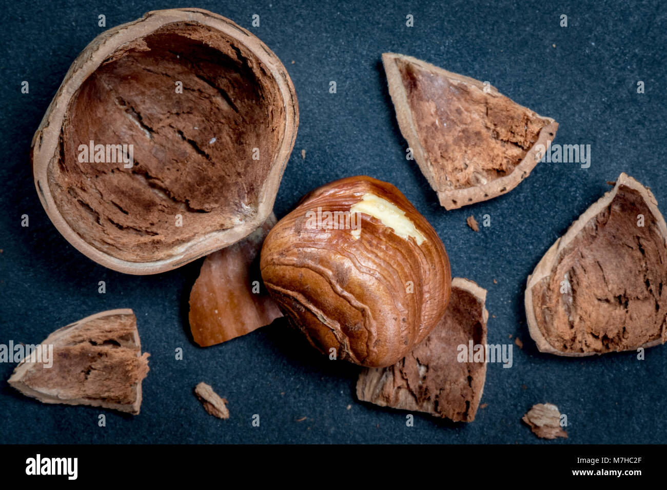 Hazelnut and Broken Shell over black slate background Stock Photo - Alamy