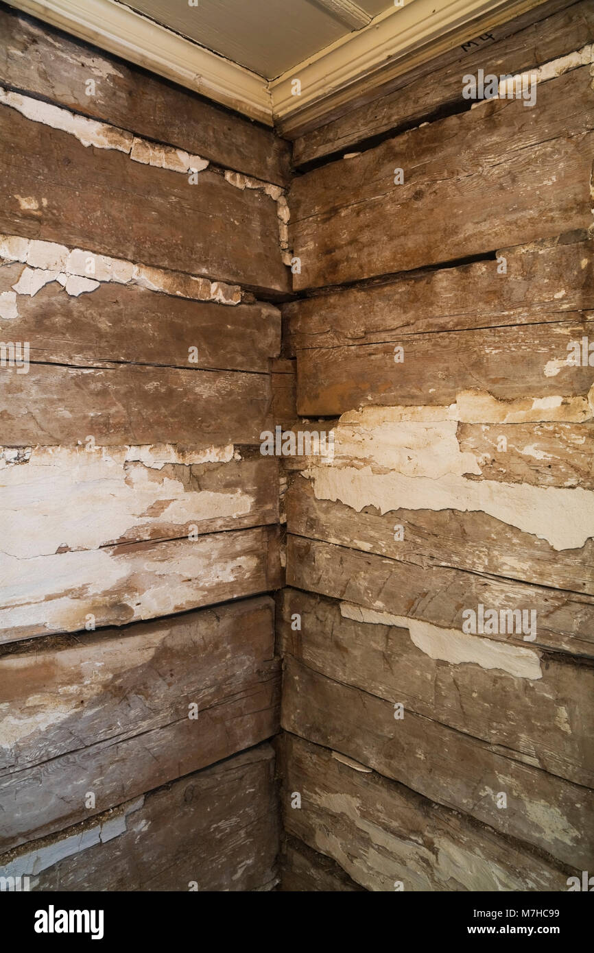 Stacked wooden beams and chunks of white plaster on walls in a room ...