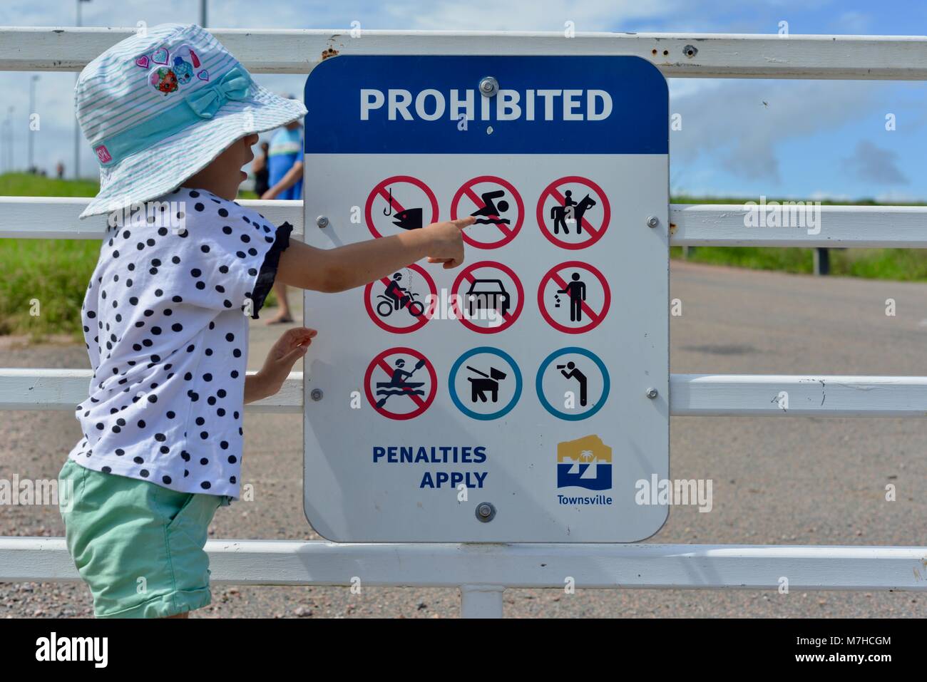 child explaining concepts on a prohibited sign to protect water supply ...