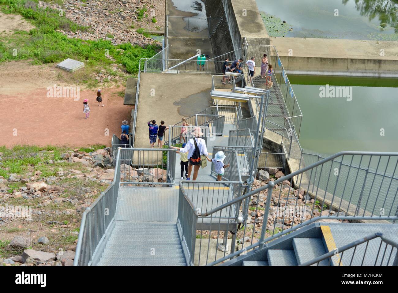 Children and adults walking down galvanised steel stairs, Ross River ...