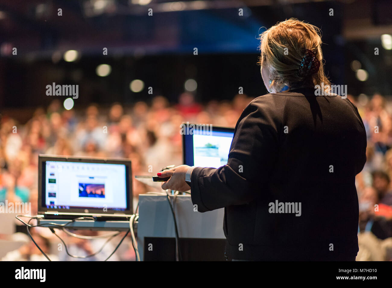 Female public speaker giving talk at Business Event Stock Photo - Alamy