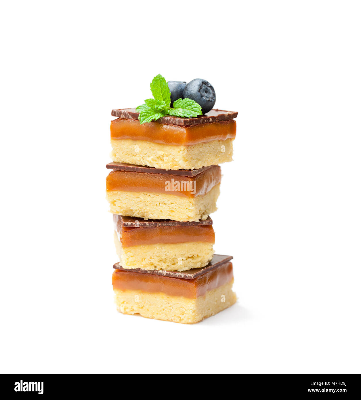 Stack of luxury millionaires shortbread with blueberry and mint leaves ...