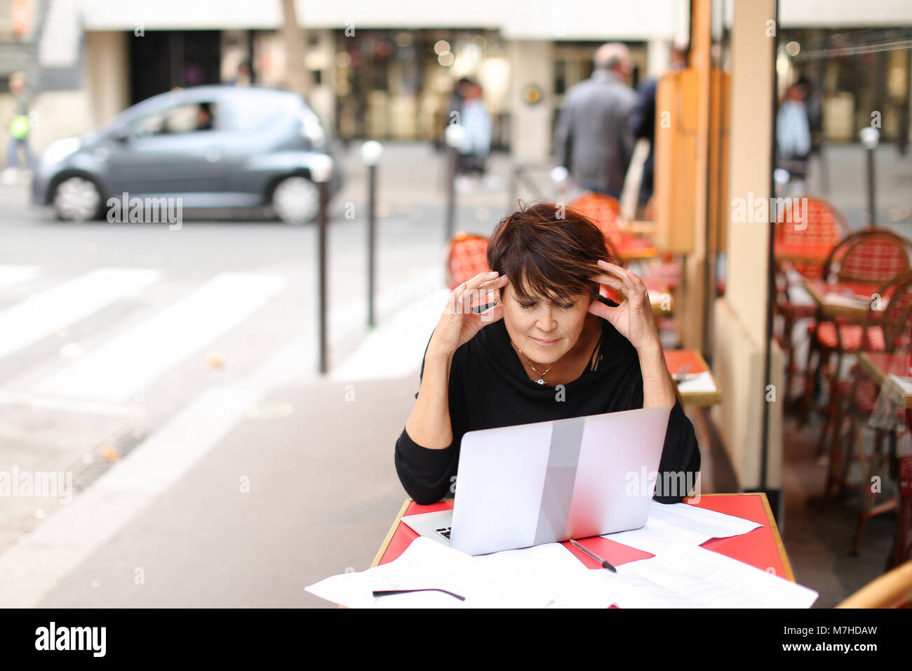 aged female screenwriter working with scenario in laptop Stock Photo ...