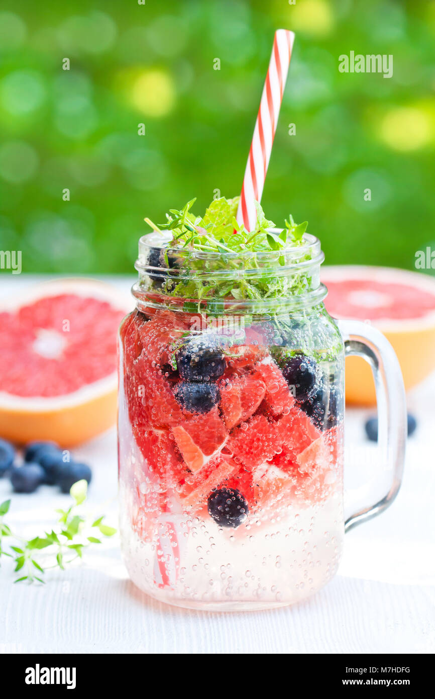 Detox water. Homemade summer fruit drink with grapefruit and blueberry ...