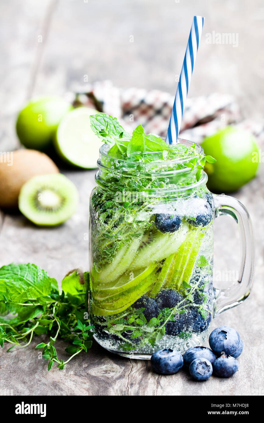 Detox water. Homemade summer fruit drink with lime and kiwi and ...