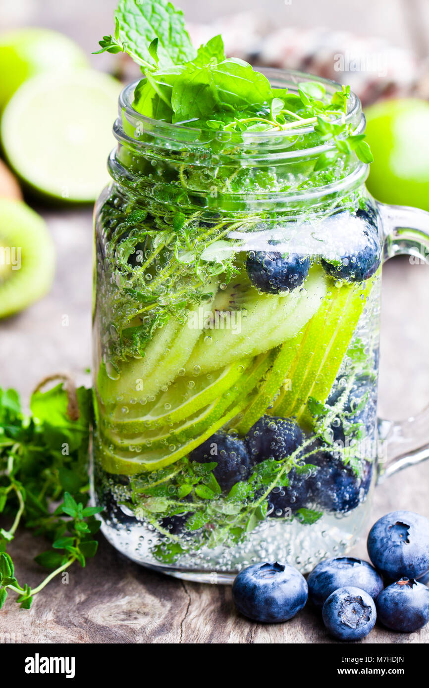 Detox water. Homemade summer fruit drink with lime and kiwi and ...