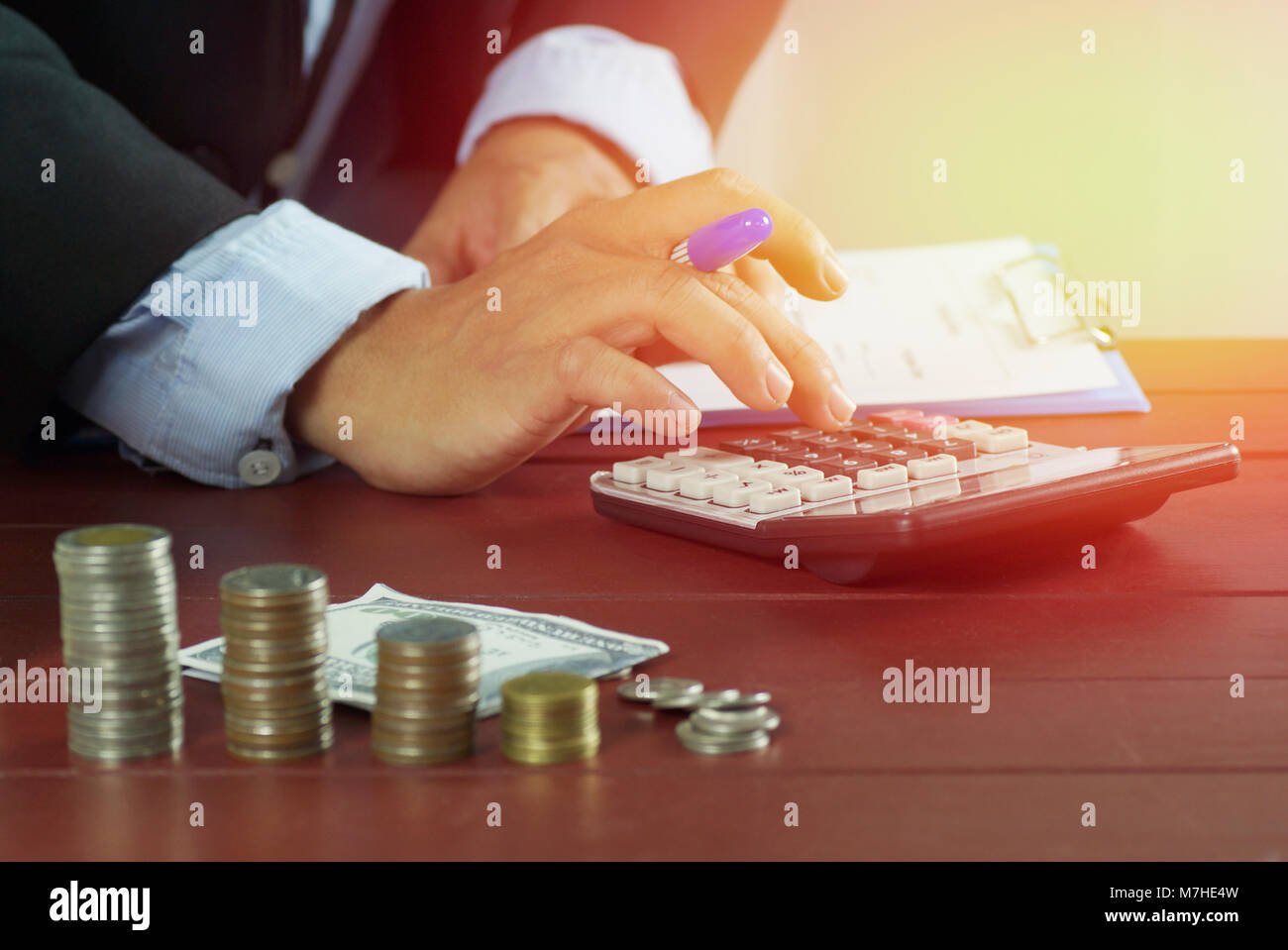 business man press calculator to count money Stock Photo - Alamy