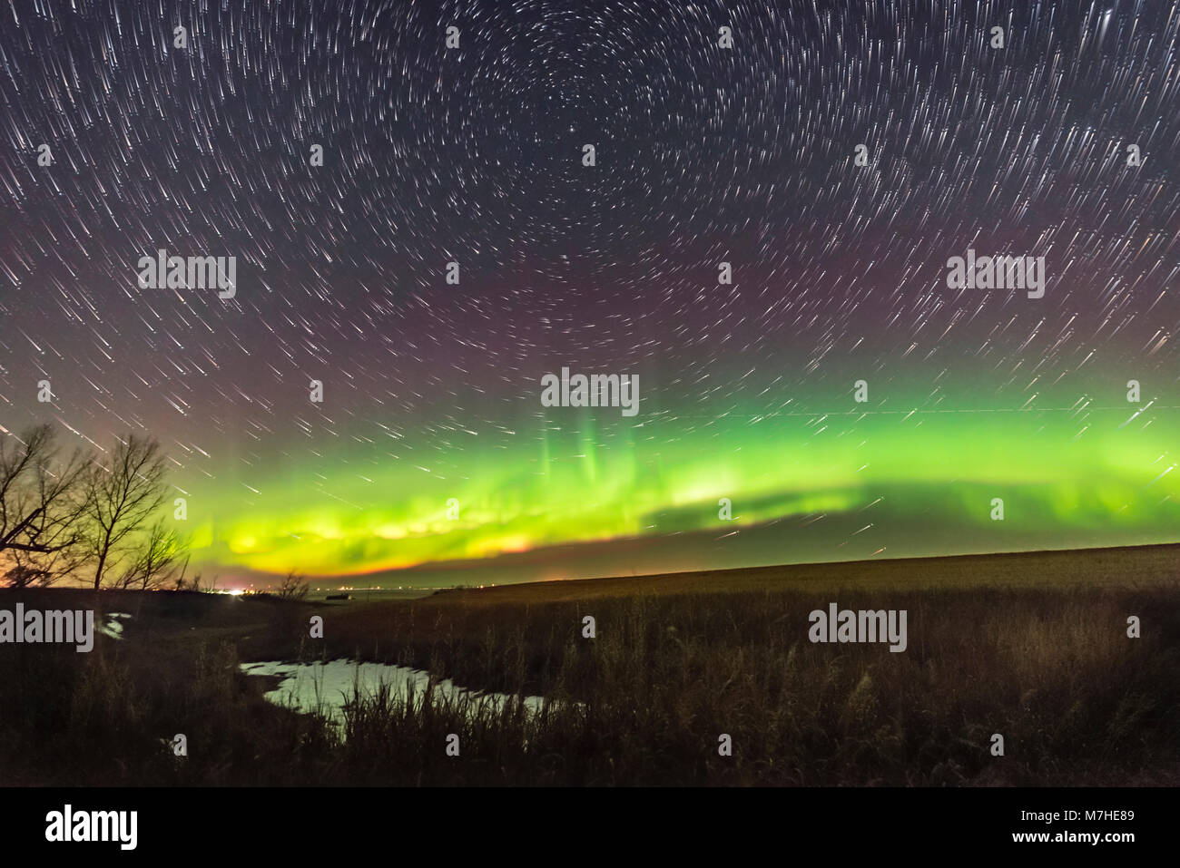 A circumpolar star trail composite with northern lights, Canada Stock ...