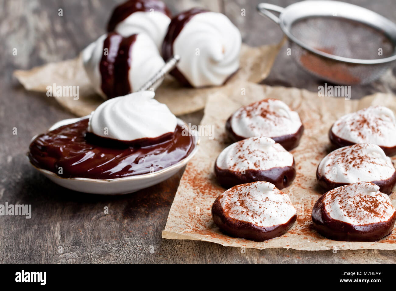 Homemade white meringues with dark chocolate Stock Photo - Alamy
