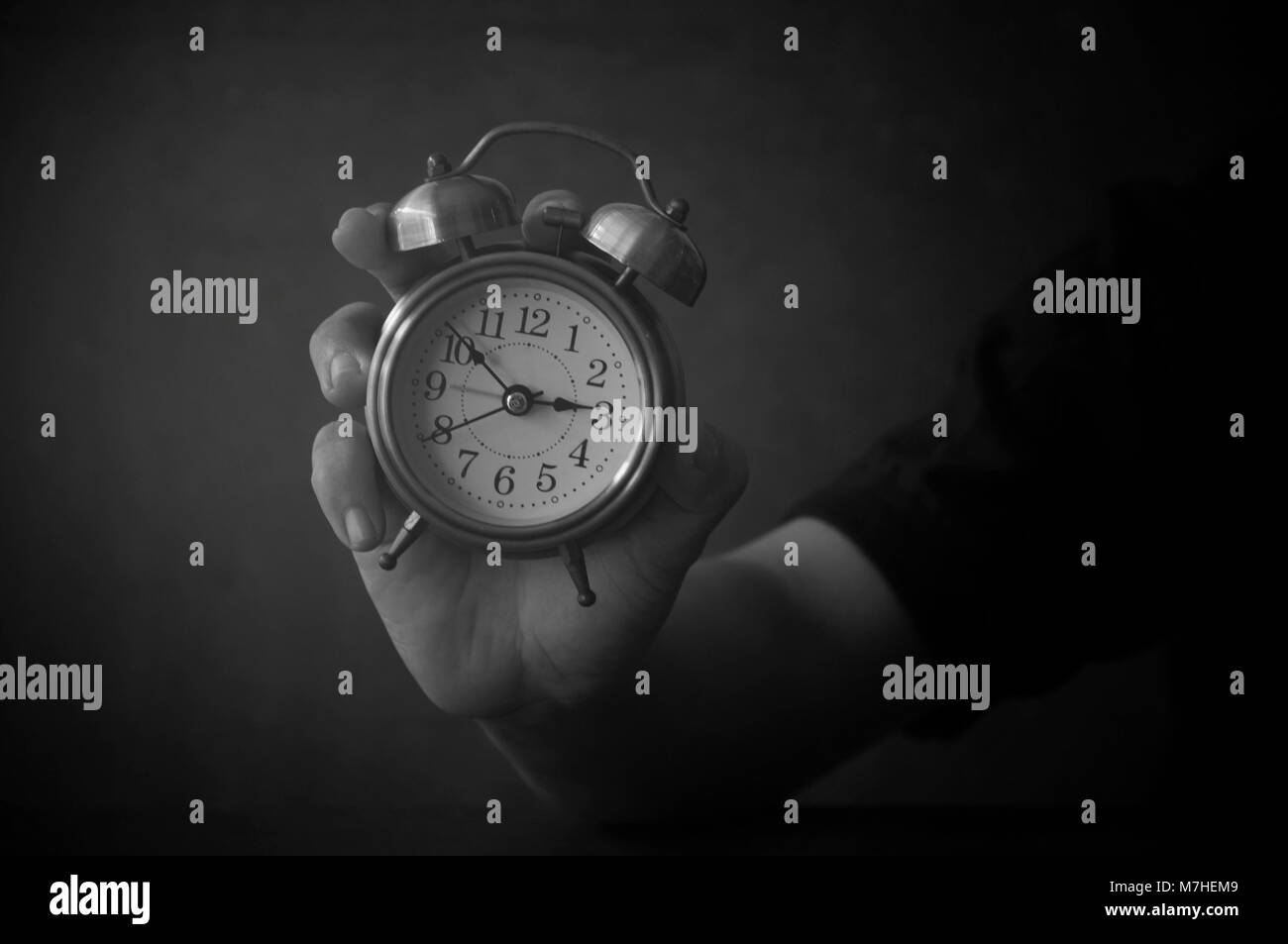 hand show clock in dark tone Stock Photo - Alamy