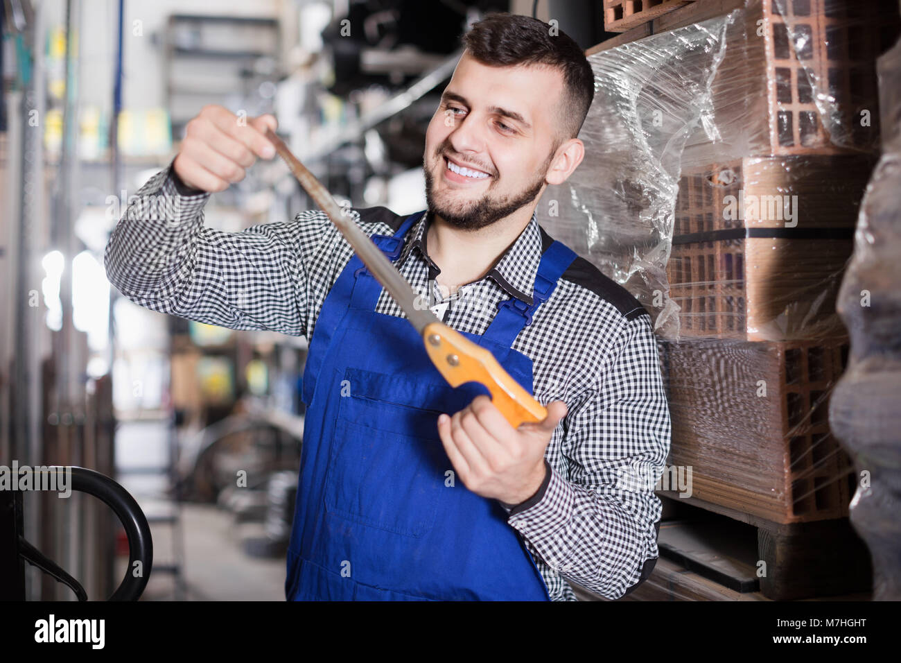 Man builder showing his working tools at workplace Stock Photo - Alamy