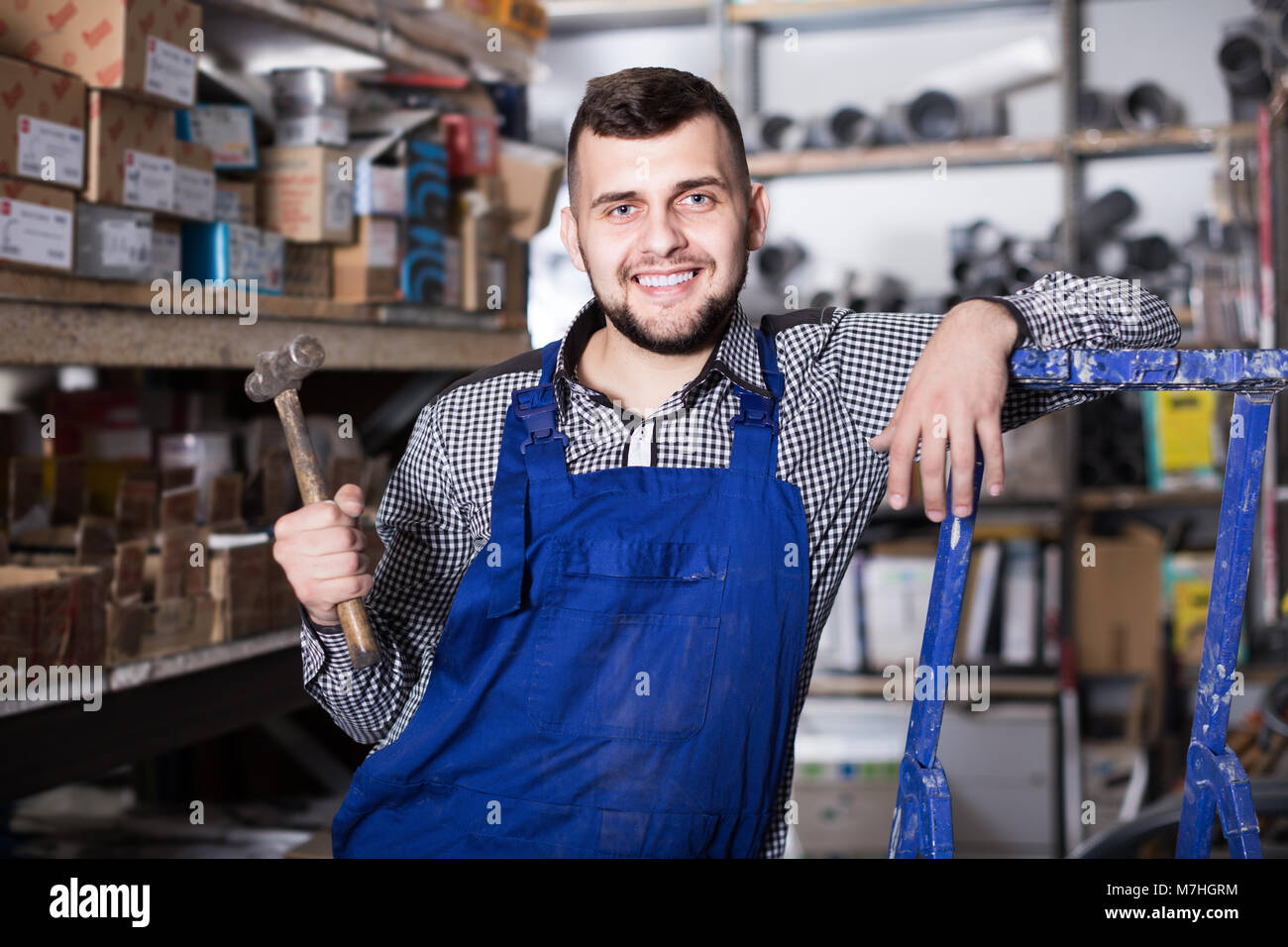 Male builder showing his working tools at workshop Stock Photo - Alamy