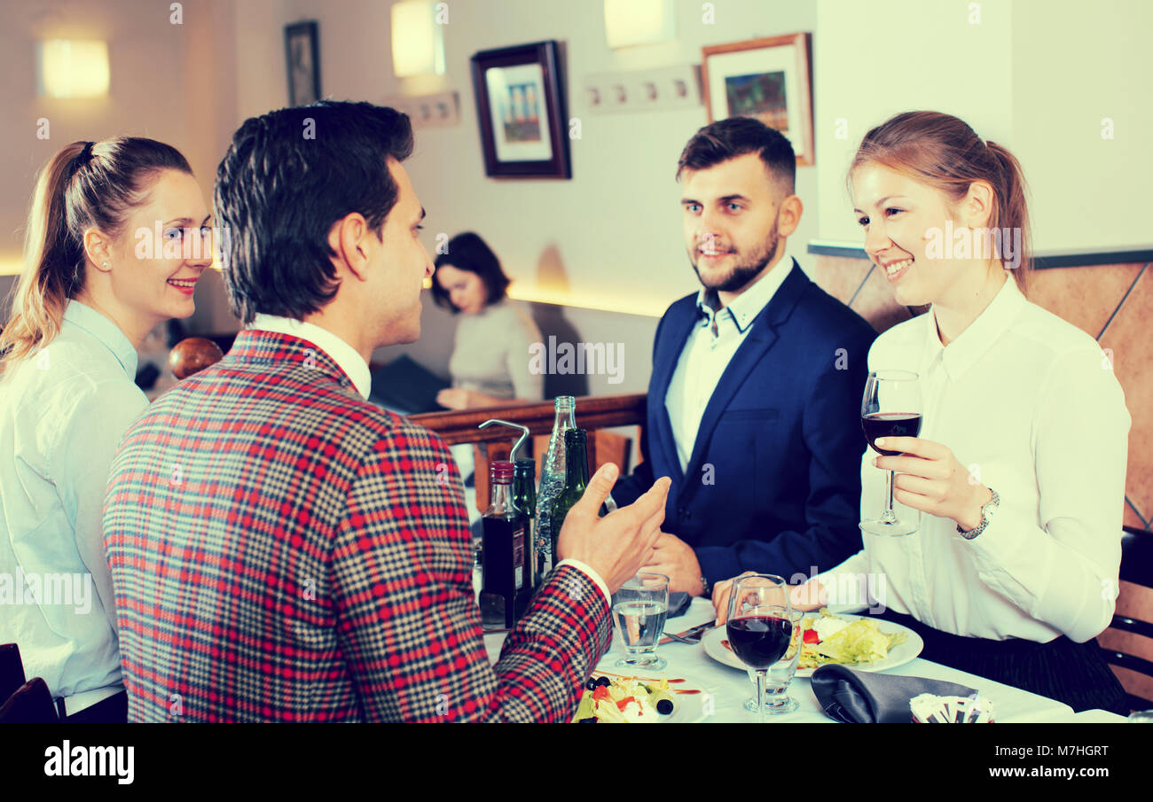 Friendly meeting over dinner with wine in restaurant Stock Photo - Alamy