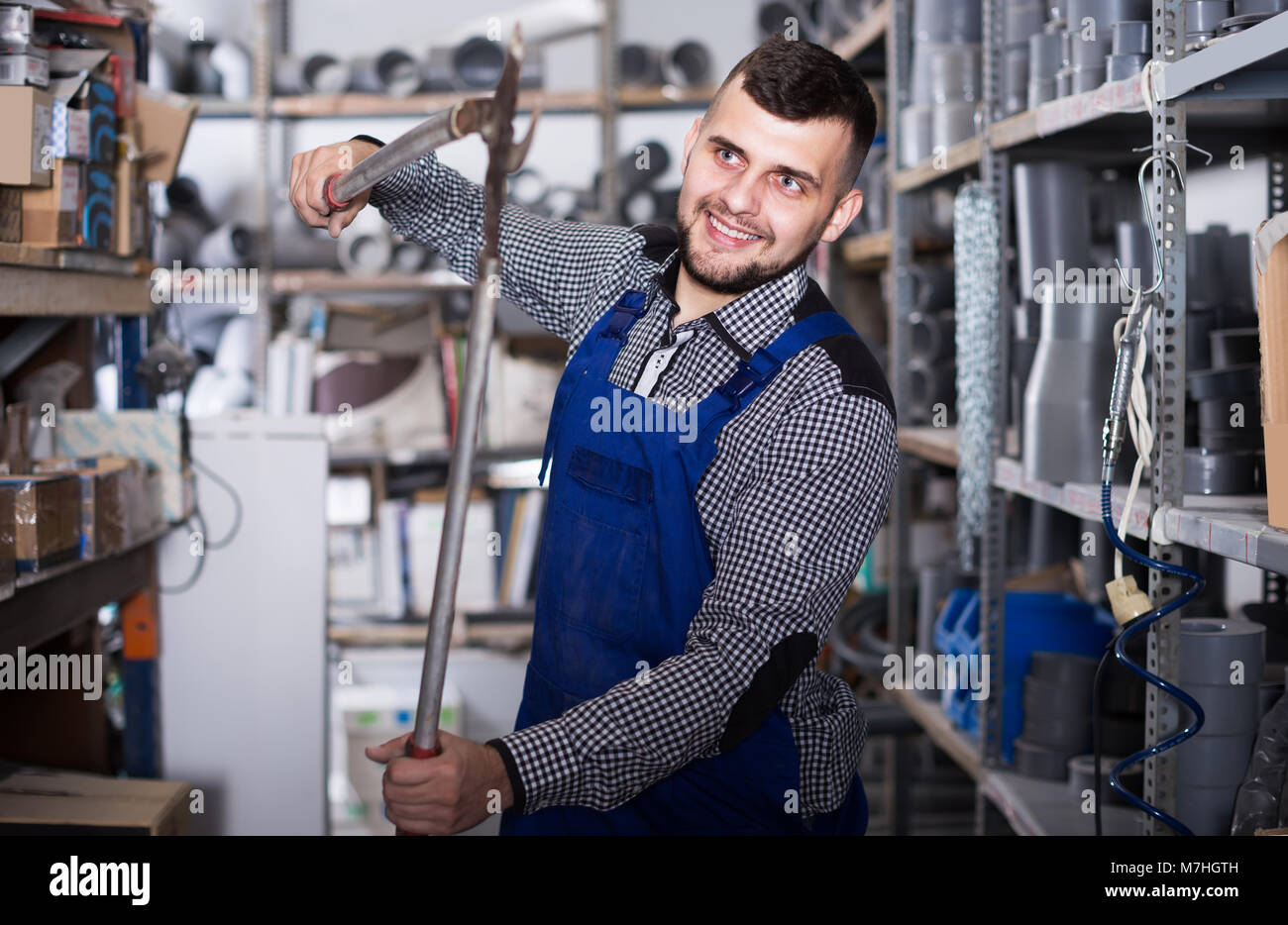 Young guy shows a variety of tools at his workplace Stock Photo - Alamy