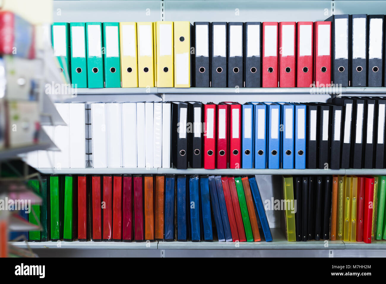 Folders standing on shelfs in the store Stock Photo - Alamy