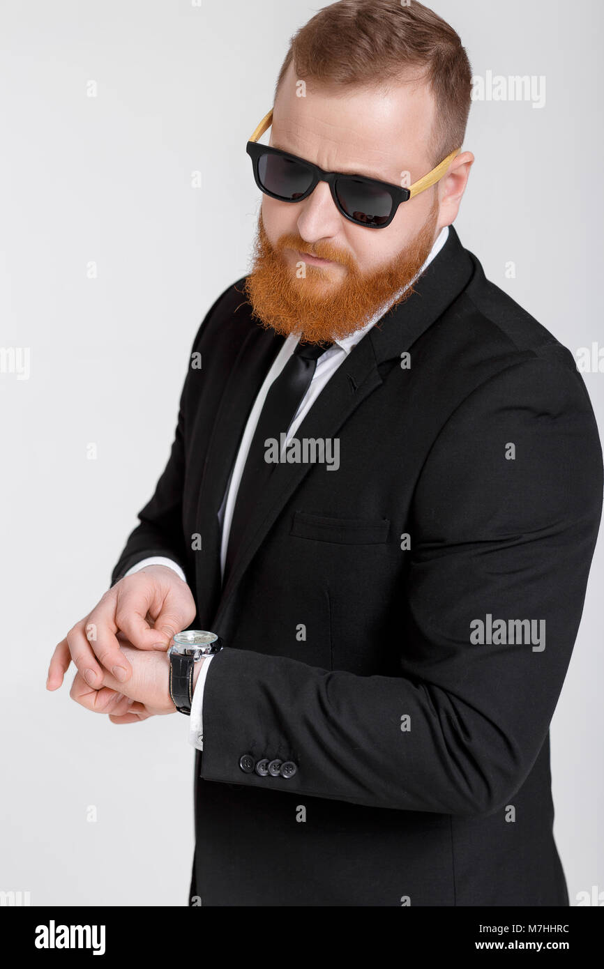Serious businessman checking time hand hi-res stock photography and ...