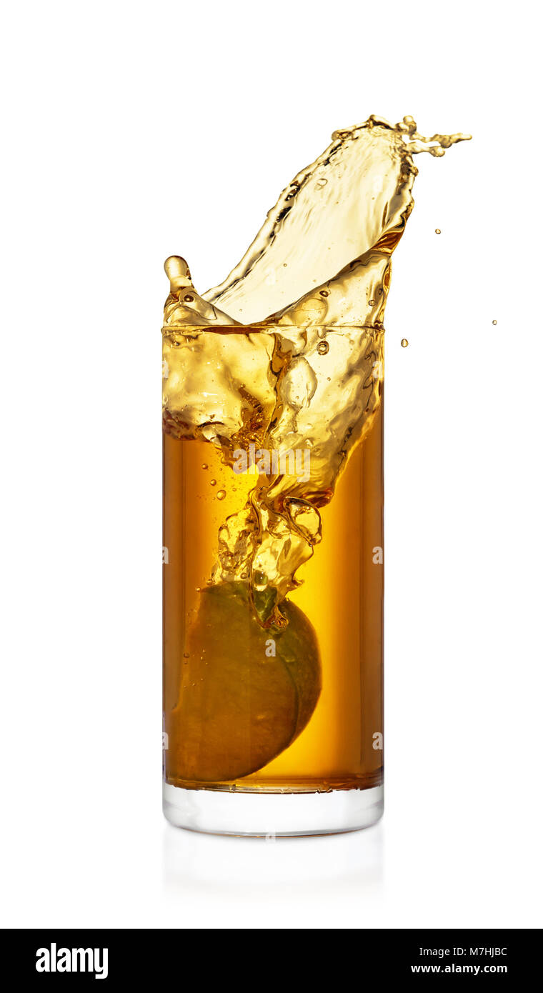 apple slice falling into juice creating splashes. Isolated on white ...