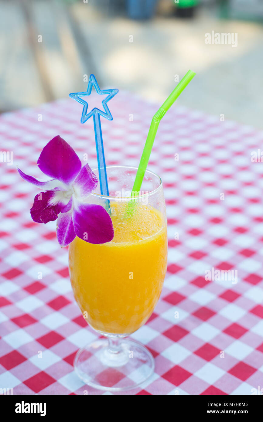 glass of fresh mango on the table with orchid Stock Photo - Alamy