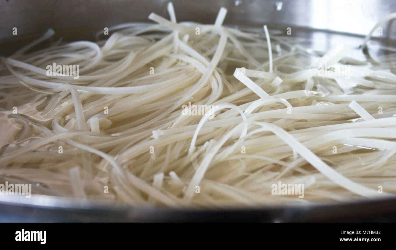 Rice noodles in the large steel saucepan. Asian cuisine Stock Photo - Alamy