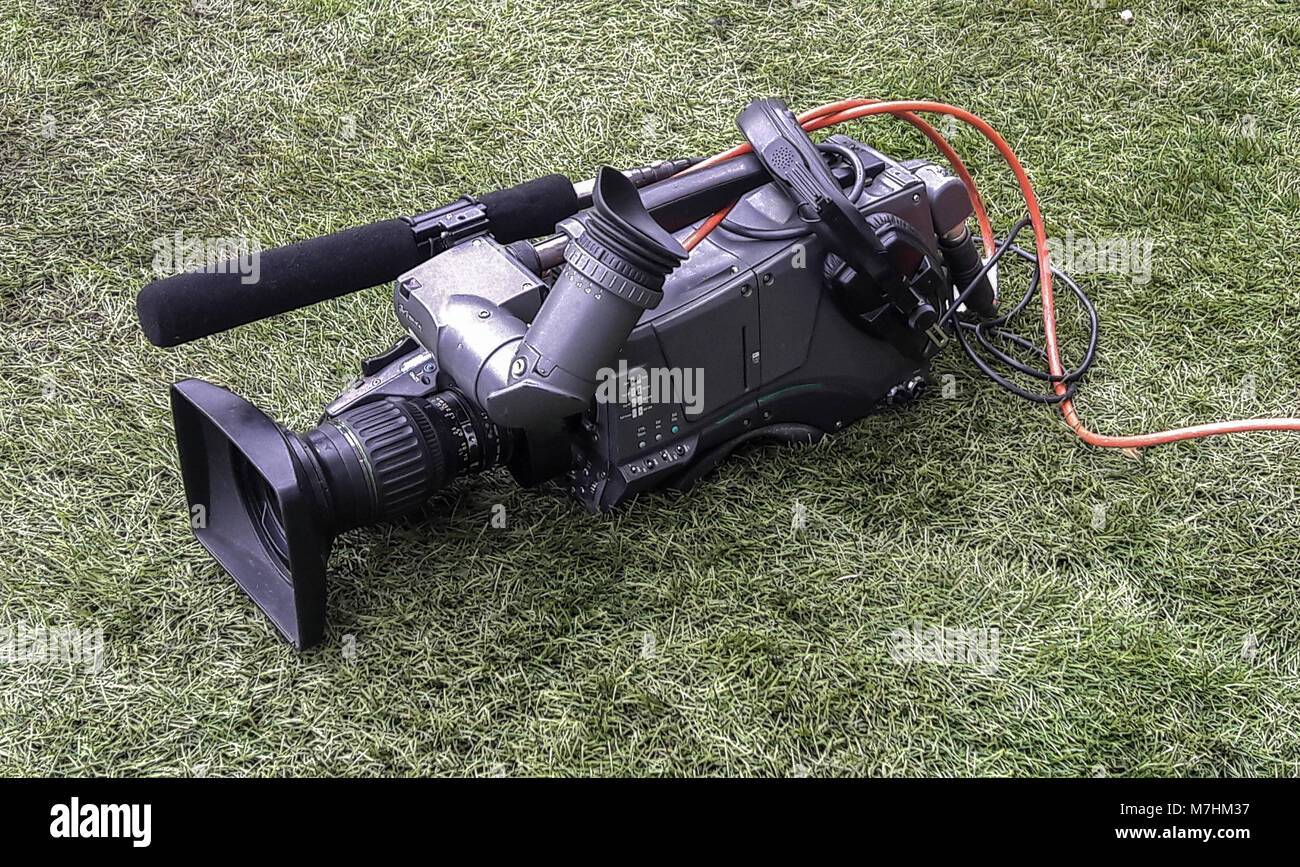 Professional digital video camera on a green background Stock Photo - Alamy