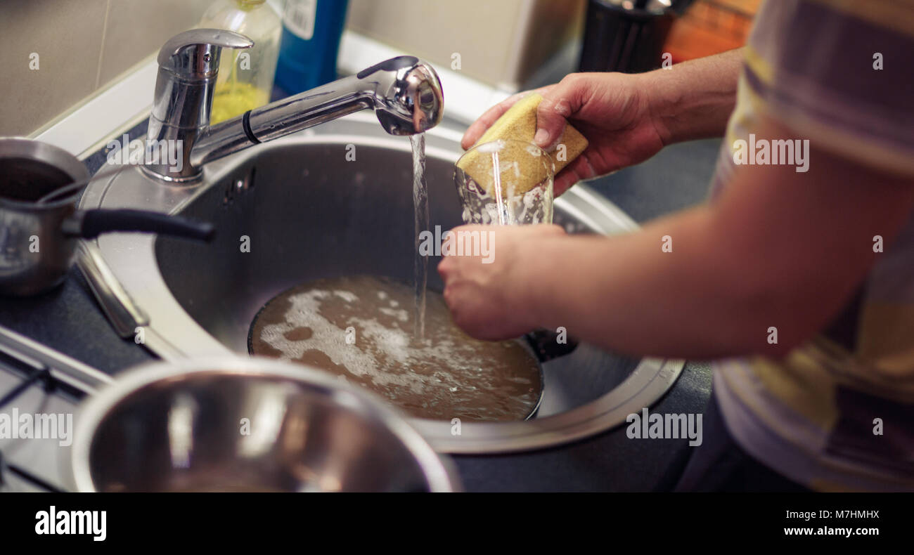 Young Man Washing Dishes In Restaurant Kitchen High Resolution Stock ...