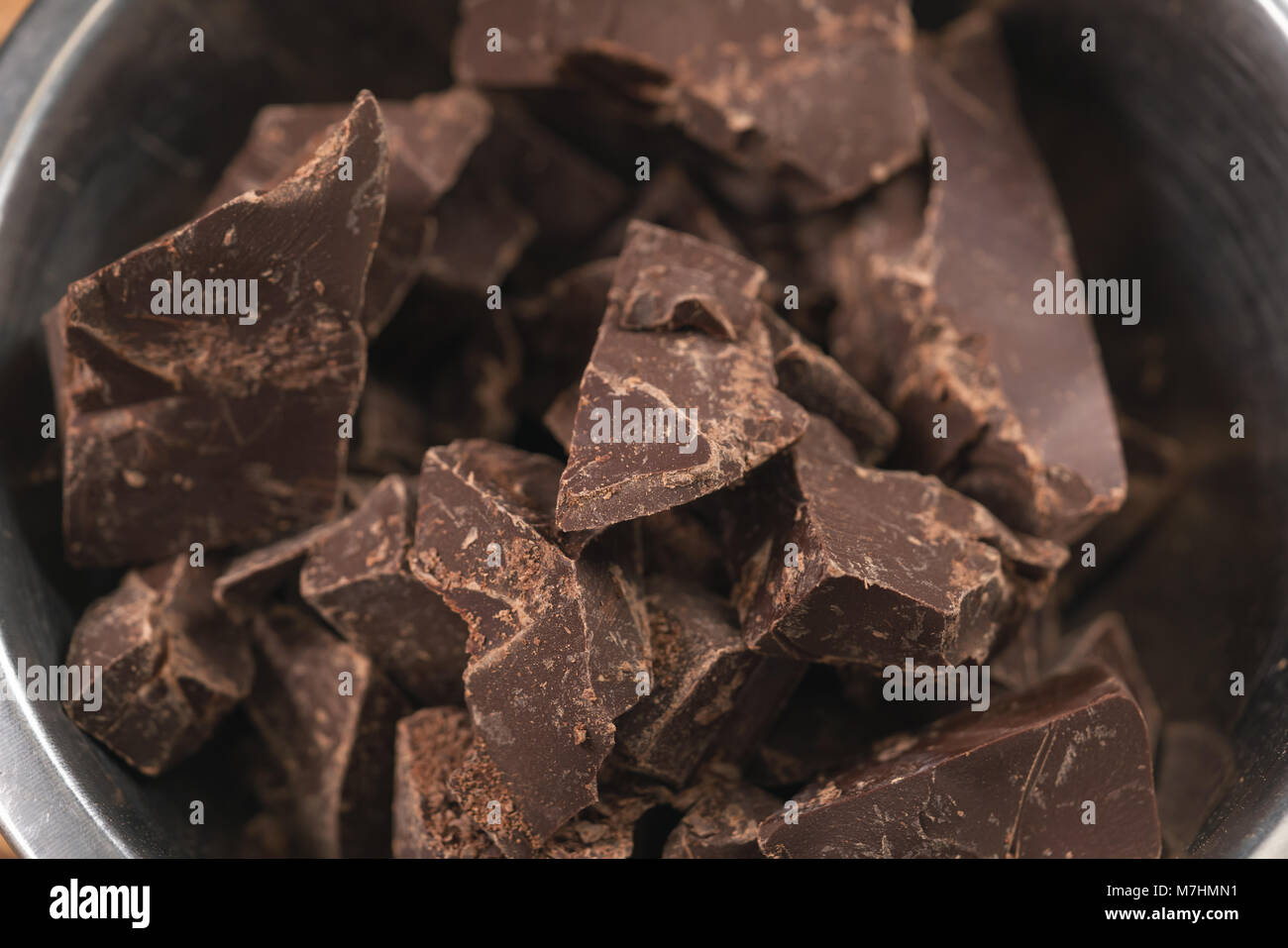 melting dark chocolate chunks in steel bowl, closeup Stock Photo - Alamy