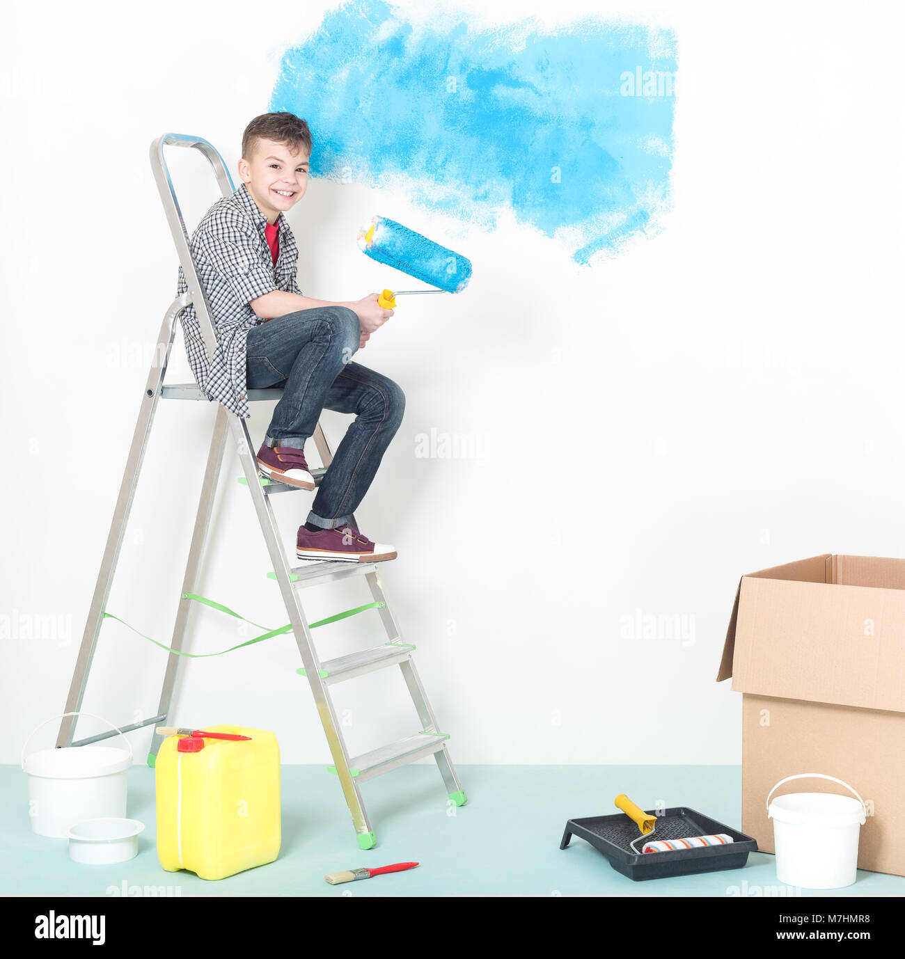 Boy with roller on adder Stock Photo - Alamy