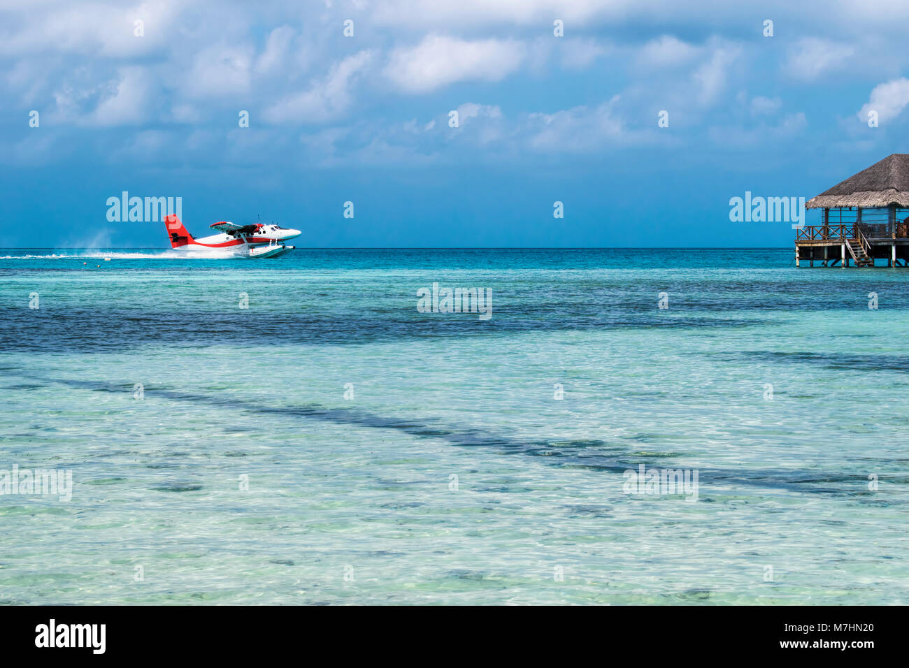 Seaplane landing in the beautiful ocean lagoon. Seaplane takeoff from ...