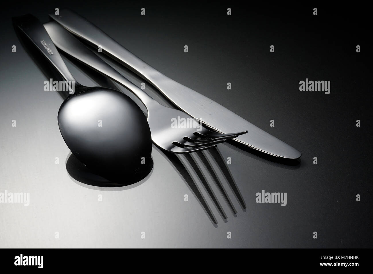 Cutlery concept over black background. Still life image of fork, spoon ...