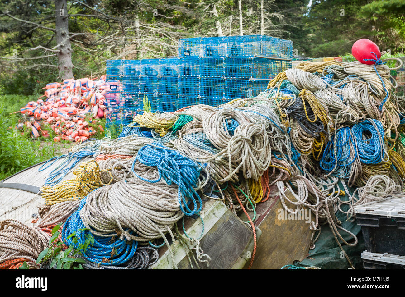 Lobstermen's ropes, cages, buoys and rowboats in storage Stock Photo ...