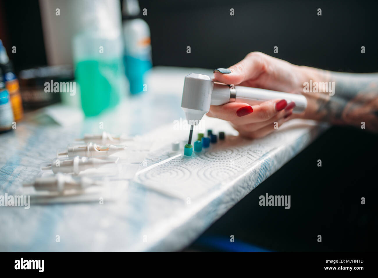 Female tattoo artist prepares color ink. Preparation for tattooing ...
