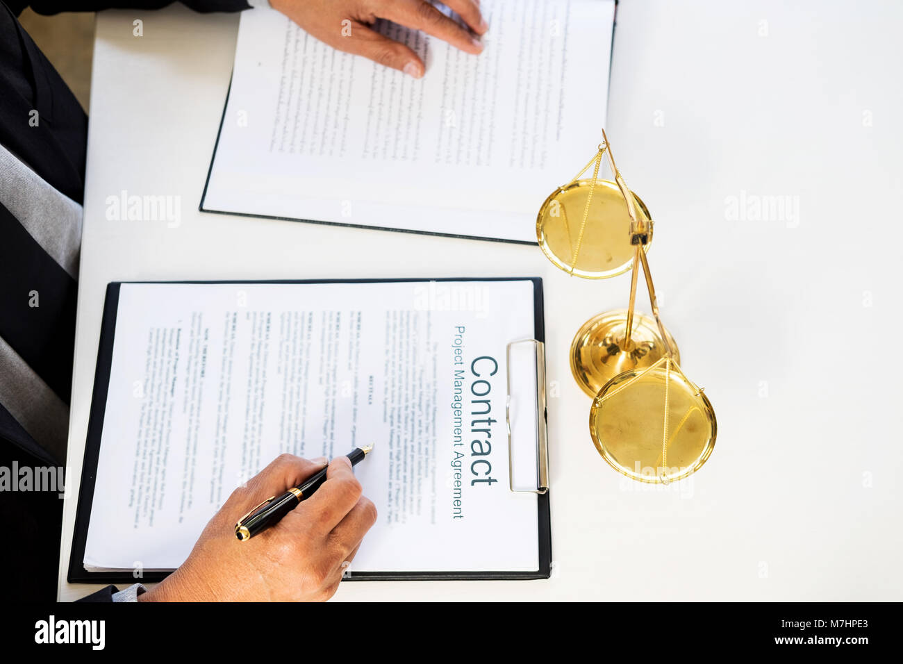 lawyer judge reading and writes the document in court at his desk Stock ...