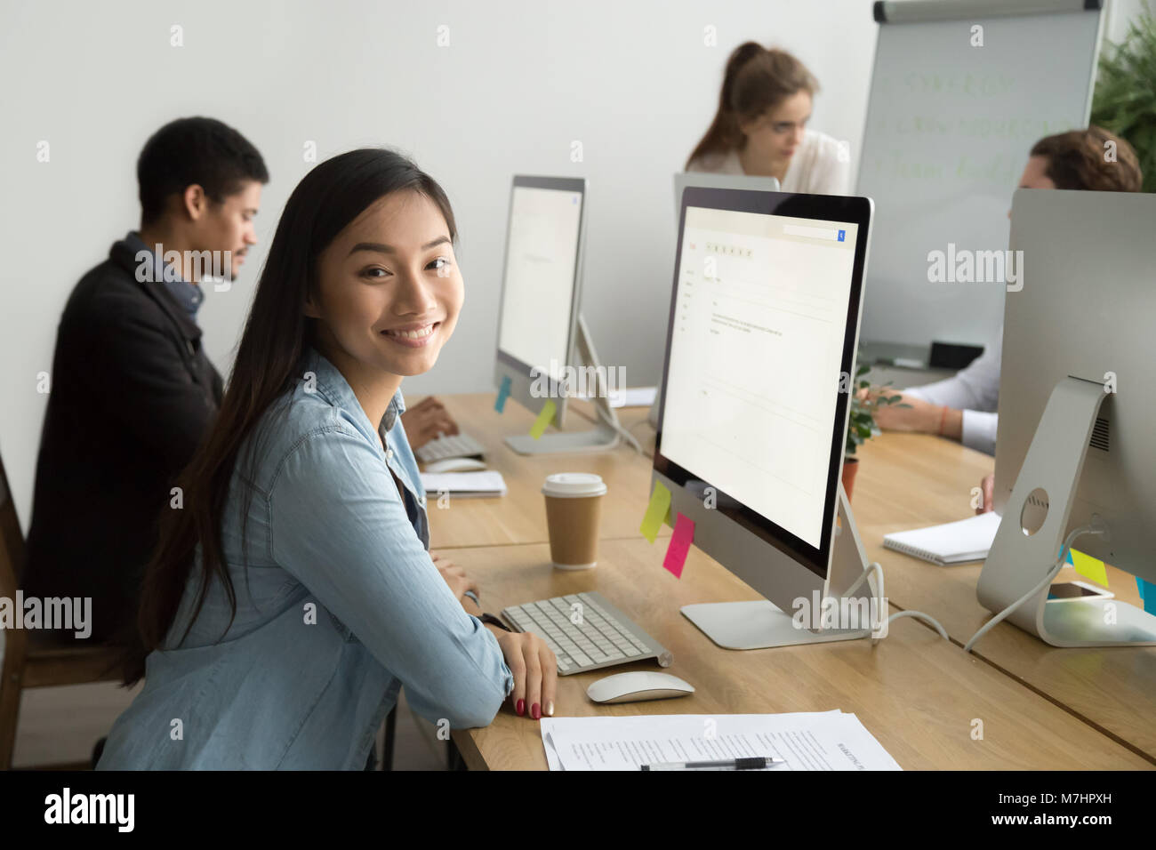 Group looking at monitor working hi-res stock photography and images ...