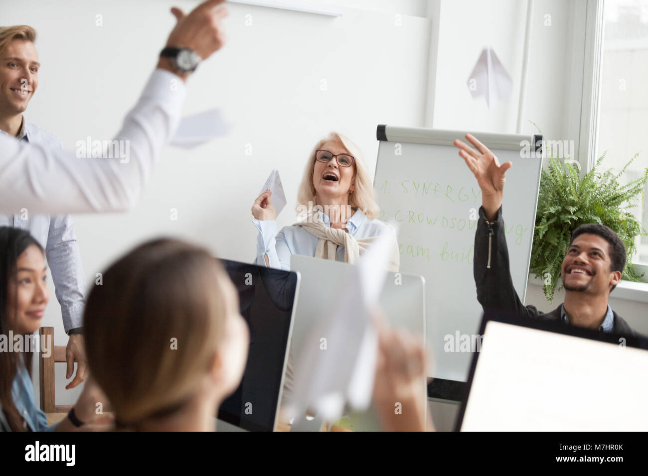 Successful team of happy diverse employees launching paper plane Stock ...