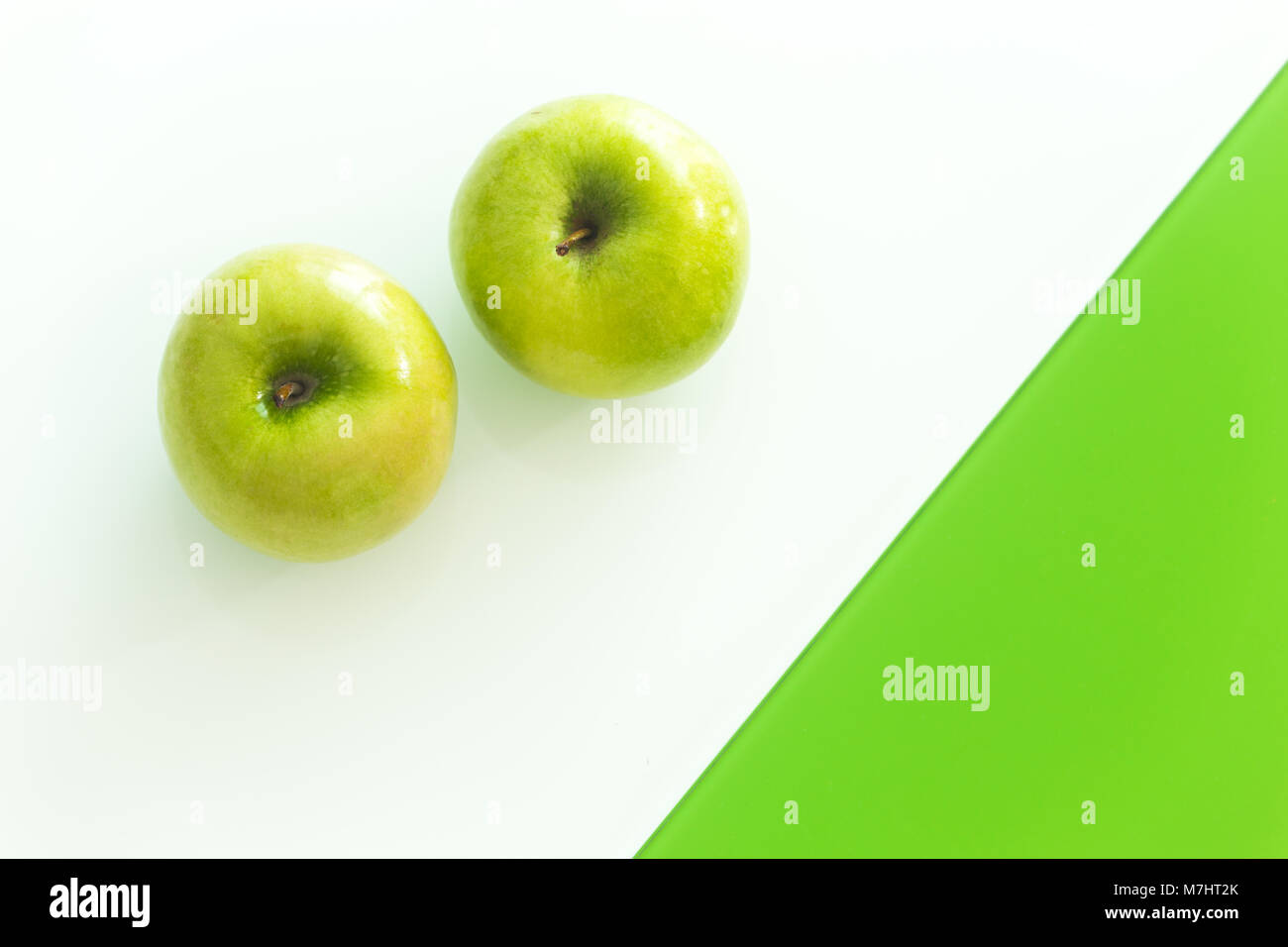 Green apple on the white-green glass background Stock Photo - Alamy