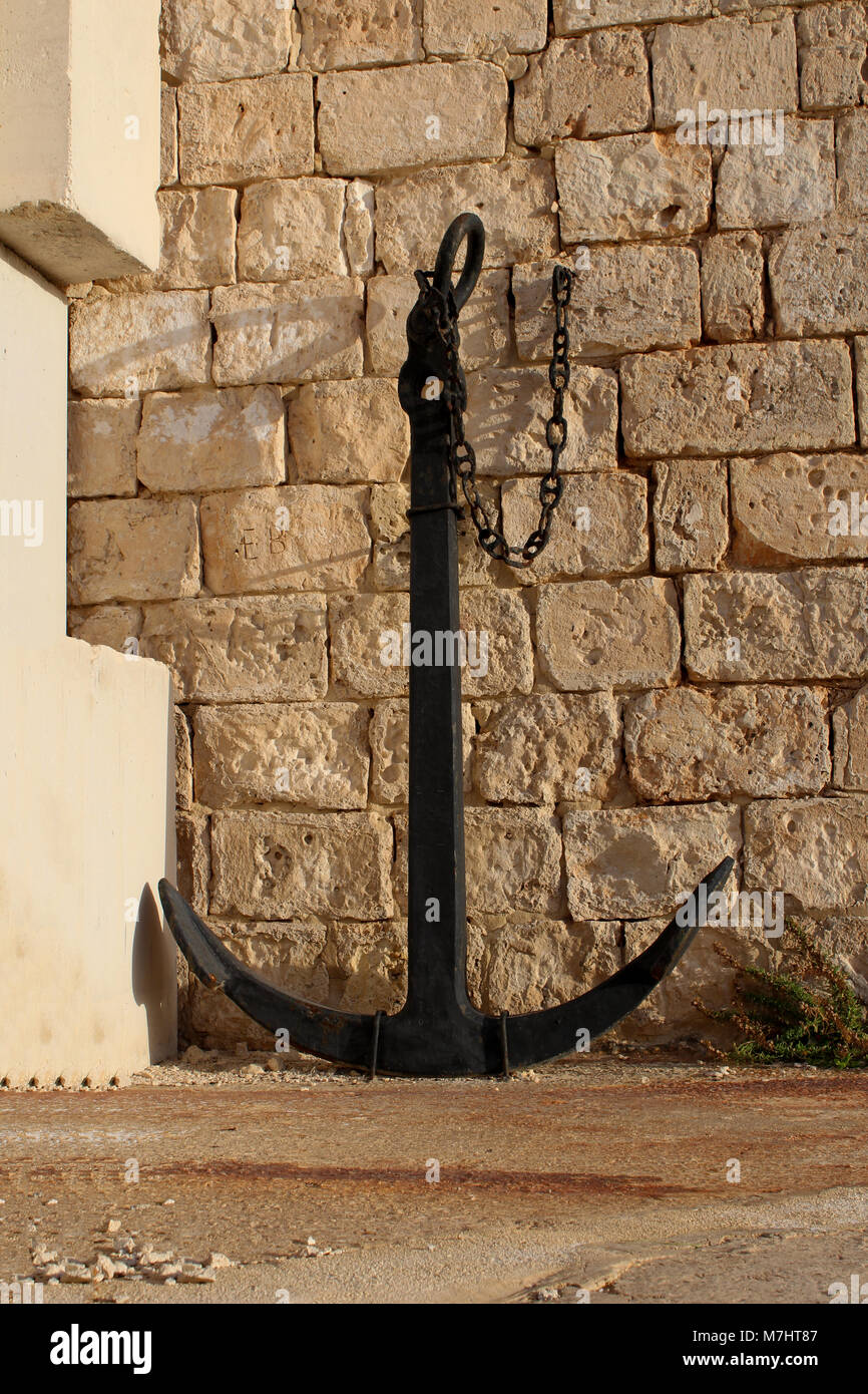 big anchor placed near the old wall malta Stock Photo - Alamy