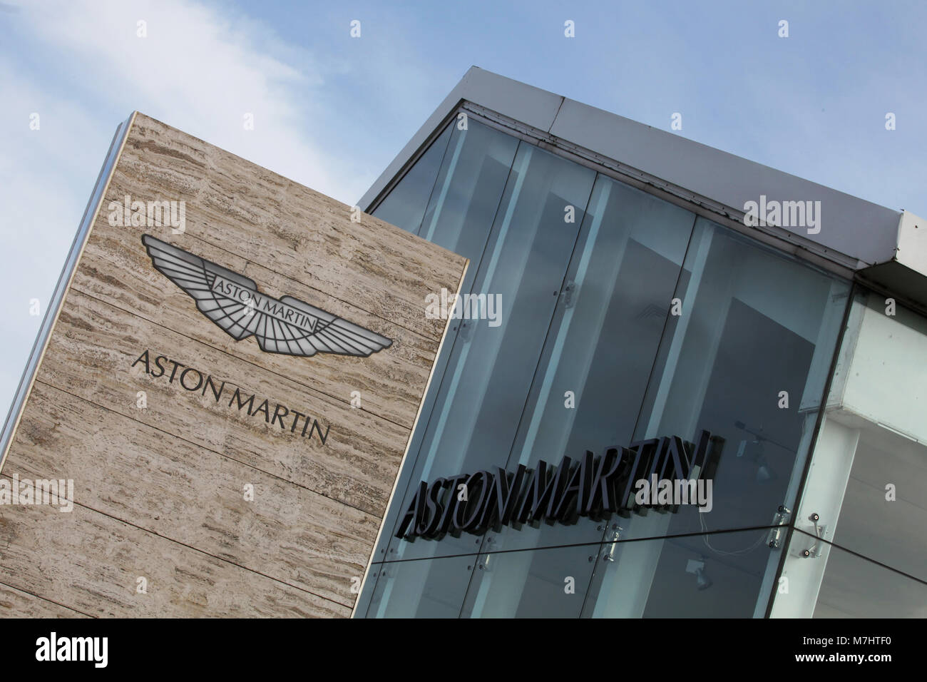The Aston Martin logo and name on the sign outside the showroom selling ...