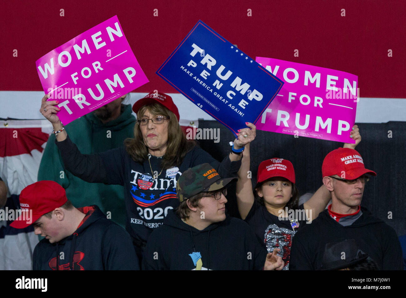 Supporters hold campaign signs during a Make American Great Rally at ...