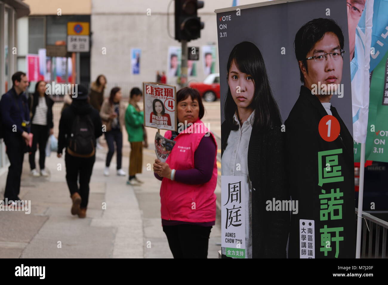Hong Kong, CHINA. 11th Mar, 2018. A pro-China campaign volunteer stands ...
