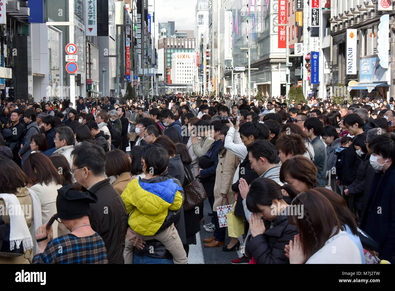 Tokyo, Japan. 11th Mar, 2018. Tens of thousands of people offer silent ...