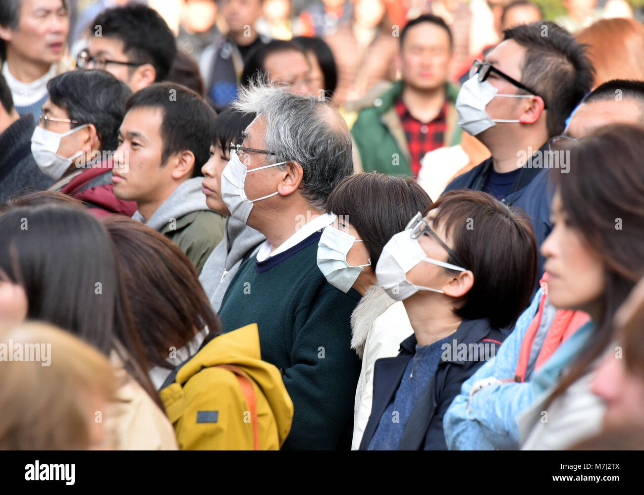 Tokyo, Japan. 11th Mar, 2018. Tens of thousands of people offer silent ...